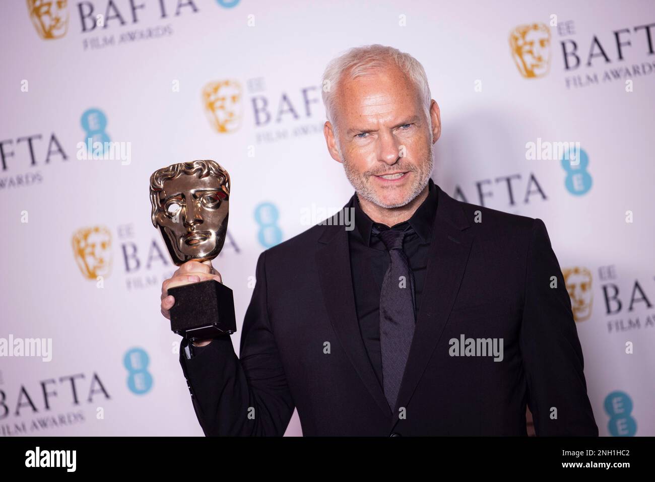Martin McDonagh poses for photographers with the Original Screenplay award for the film 'The ...
