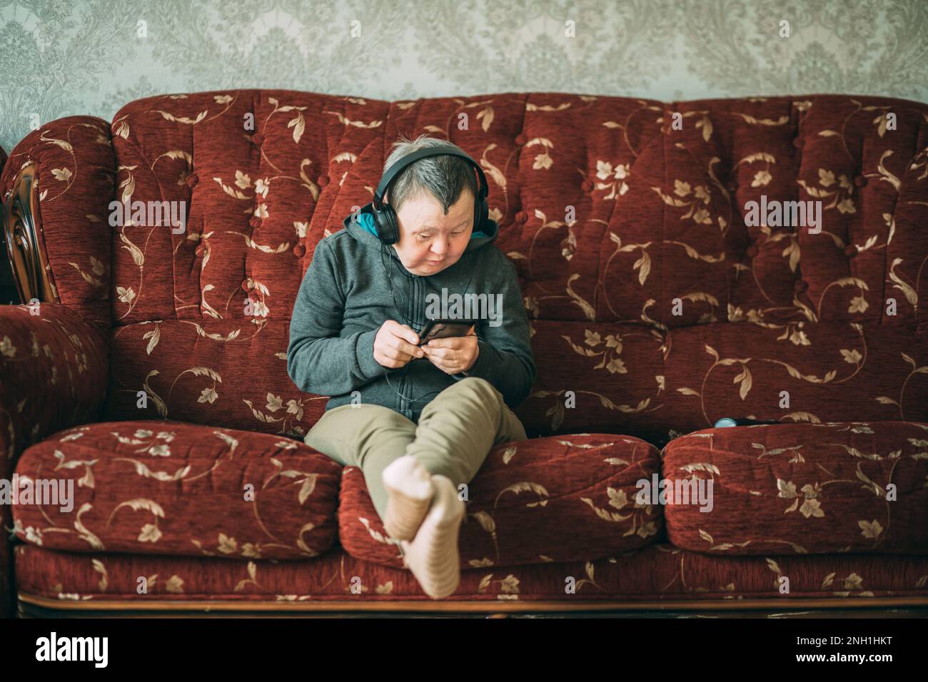 elderly woman with down syndrome with smartphone and headphones Stock ...