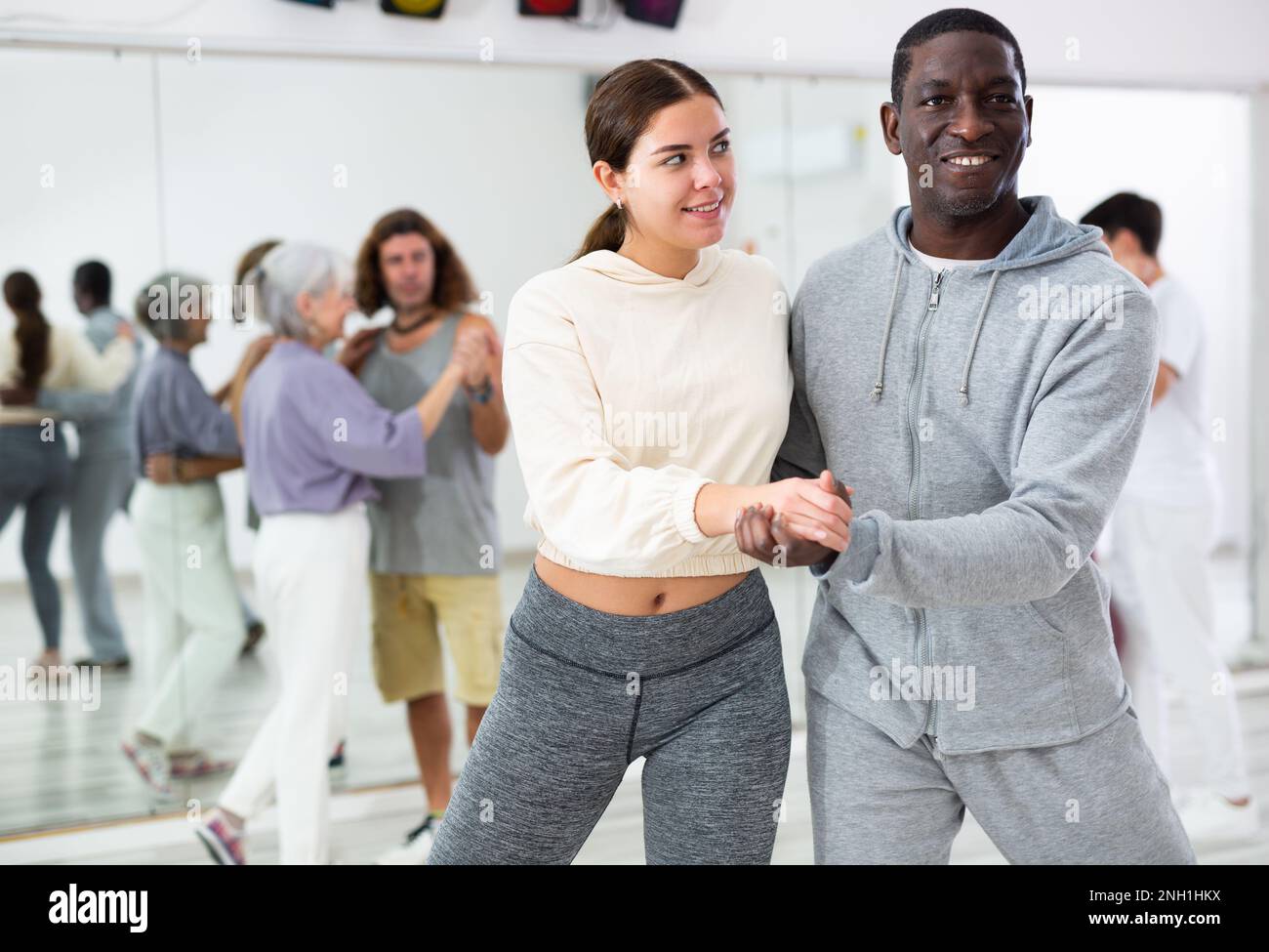 Adult couple of dancers learns partner dance Stock Photo - Alamy