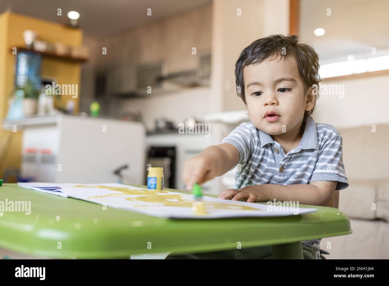 Boy paints with tempera colors paints in her living room Stock Photo ...