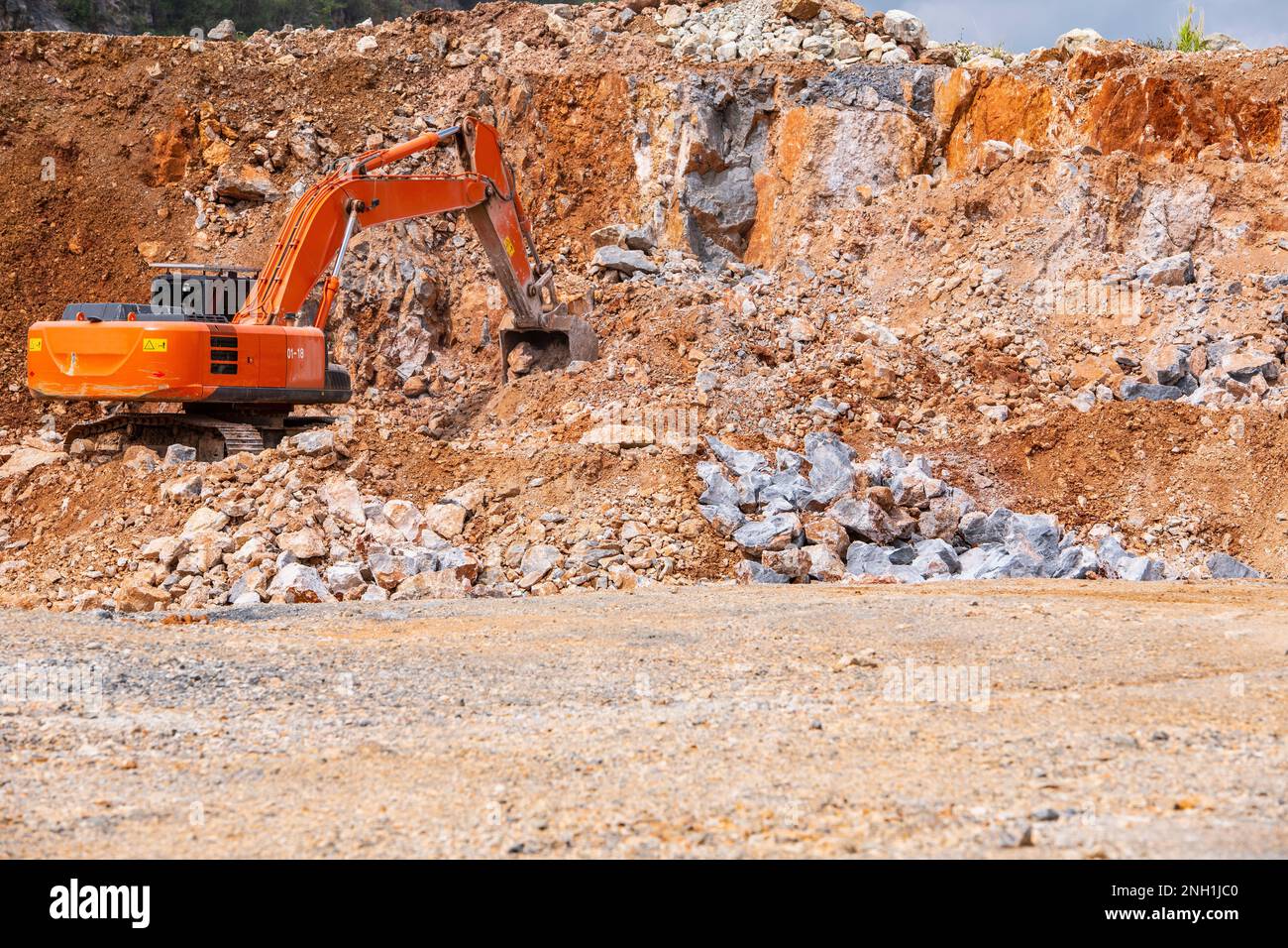excavator working at gravel mine in Thailand Stock Photo - Alamy