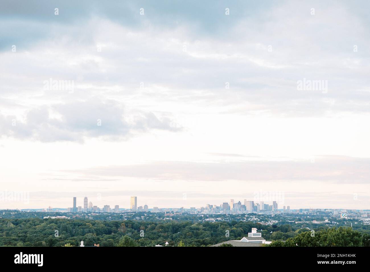 Big cloud-spotted sky with Boston skyline across bottom Stock Photo - Alamy