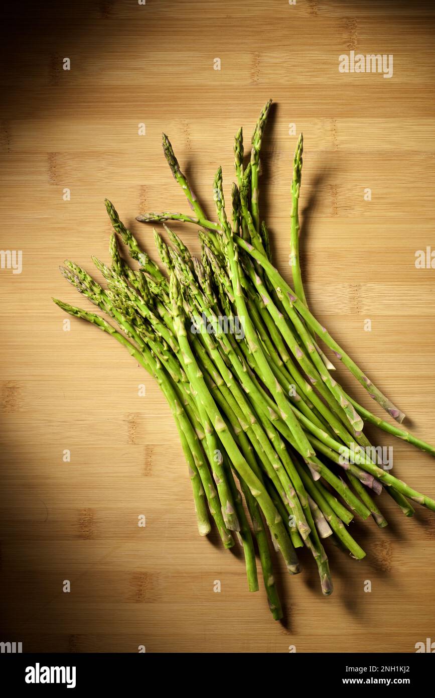 Bunch of wild asparagus on a bamboo table Stock Photo - Alamy