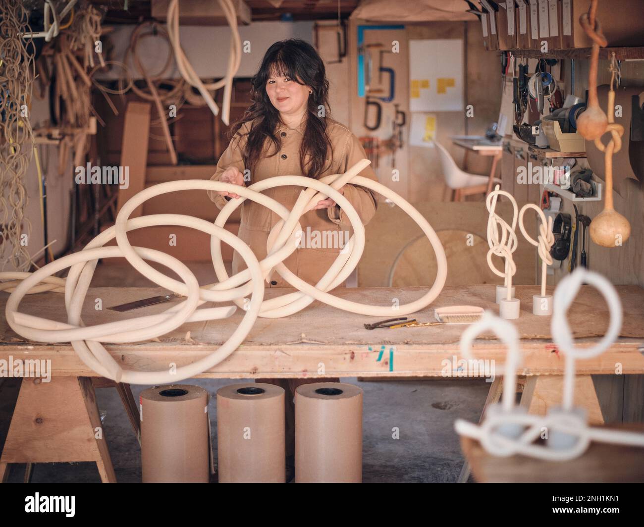 A female wood sculptor in her studio works with one of her pieces Stock ...
