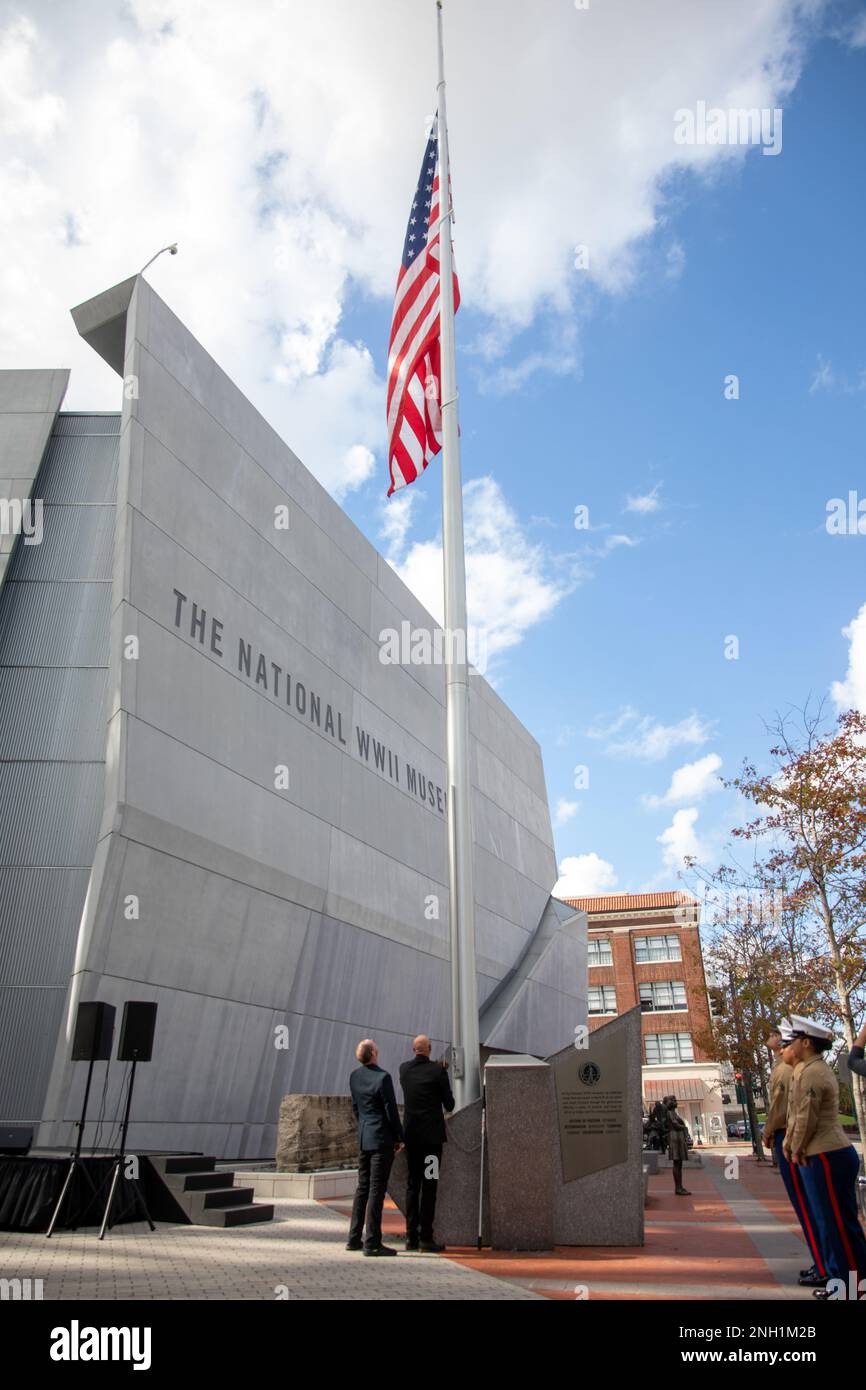 Employees of the National World War II Museum lower the flag during a remembrance ceremony for ...
