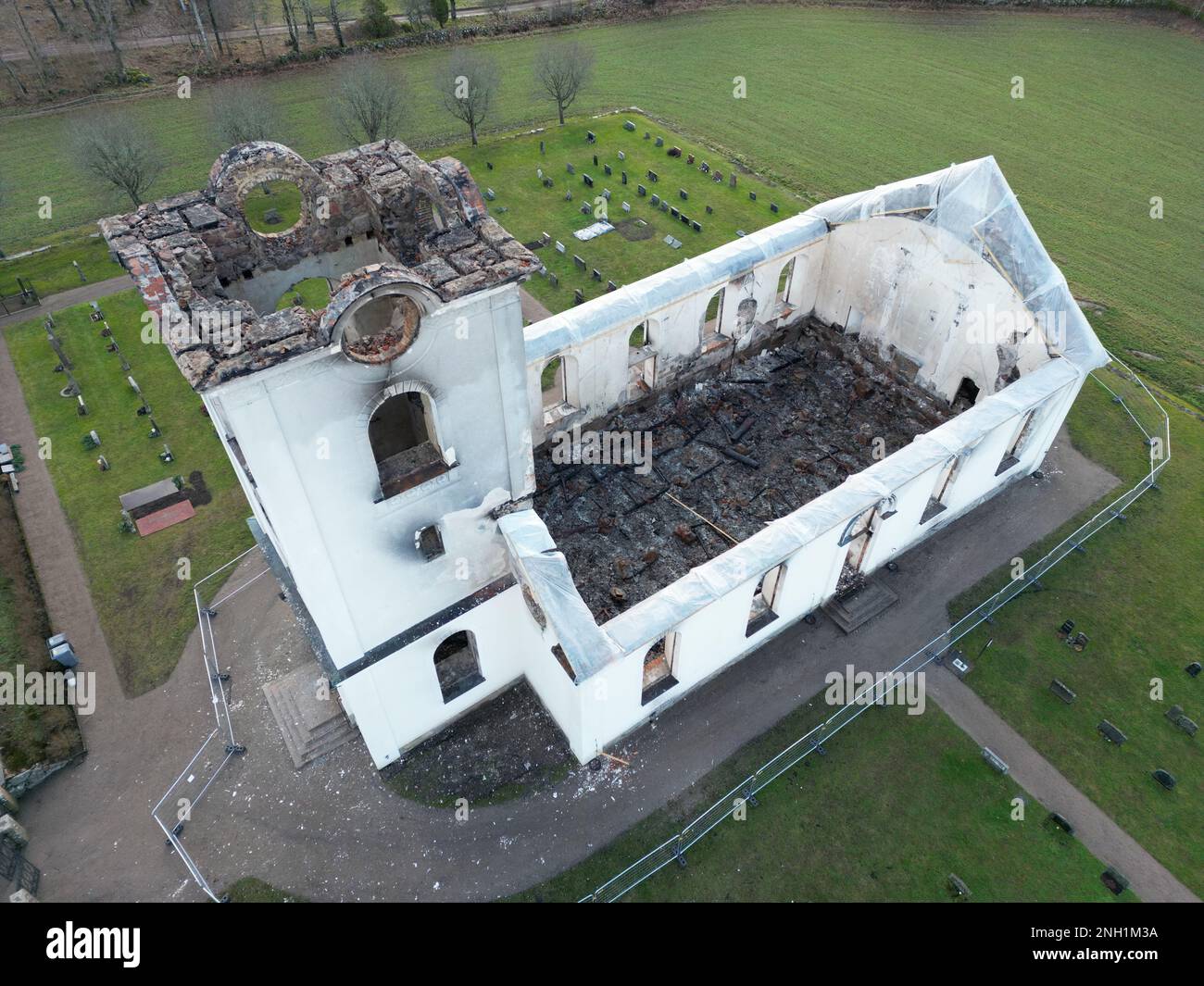 Aerial view of a house destroyed by a fire, revealing charred remains ...