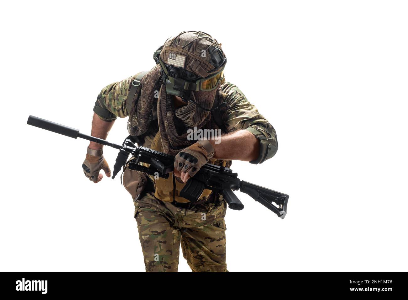 A running mercenary soldier with an automatic rifle looks back while ...