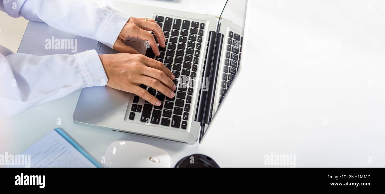 Hands of female doctor wear uniform in hospital she typing information ...