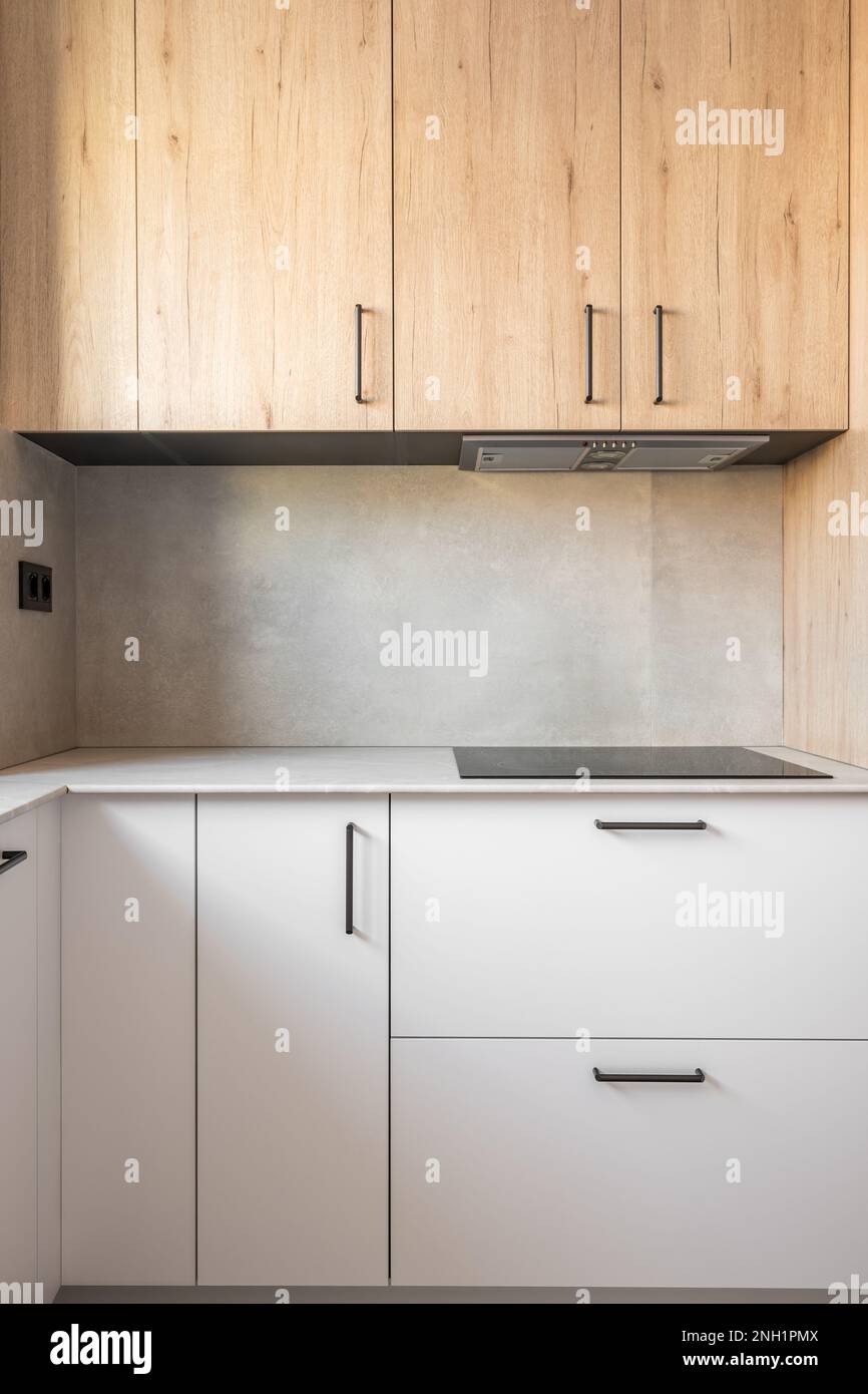 Part of kitchen with a table along wall. Table with gray marble top and ...