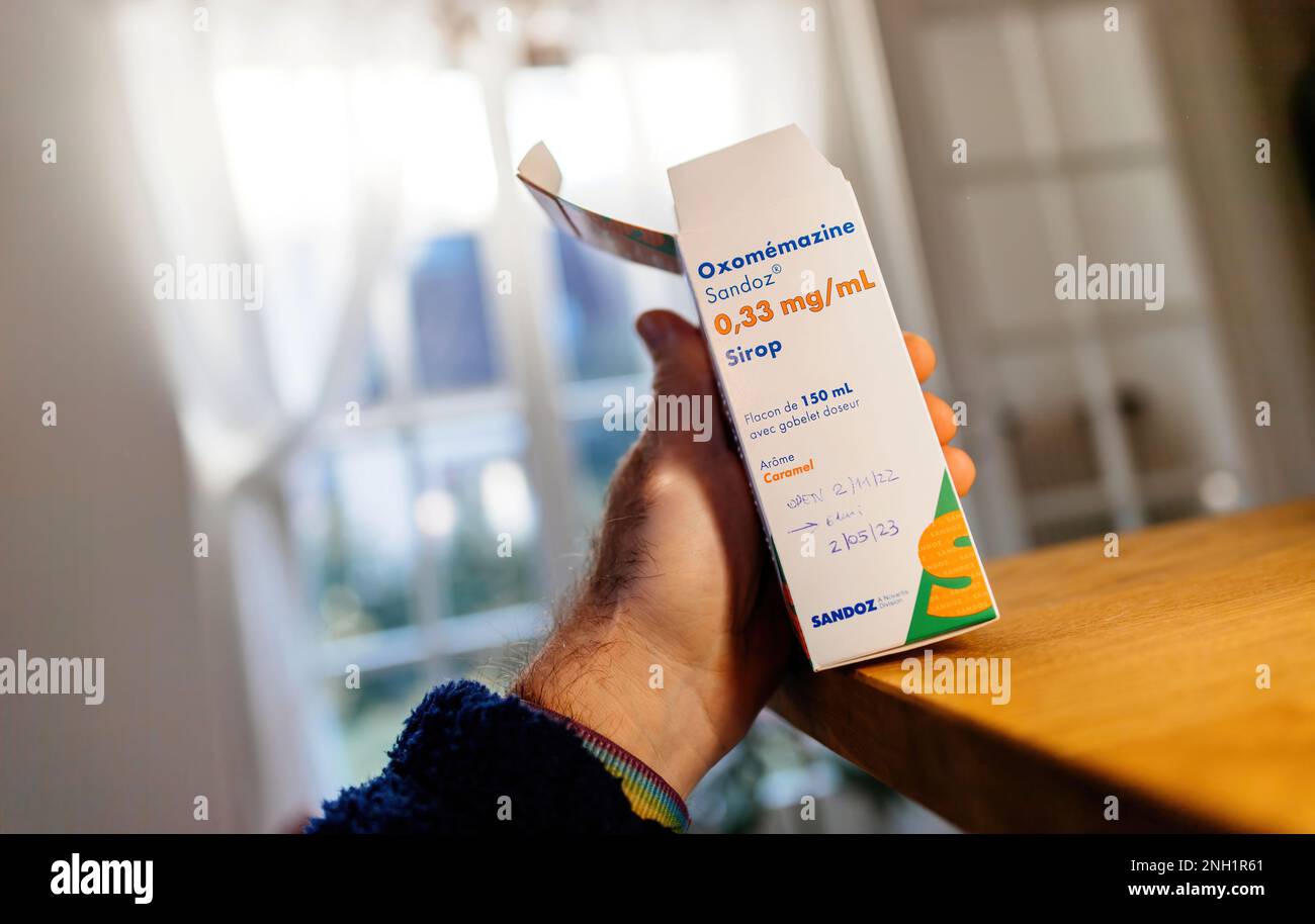 Paris, France - Feb 8, 2023: POV male hand holding Oxomemazine pack an ...