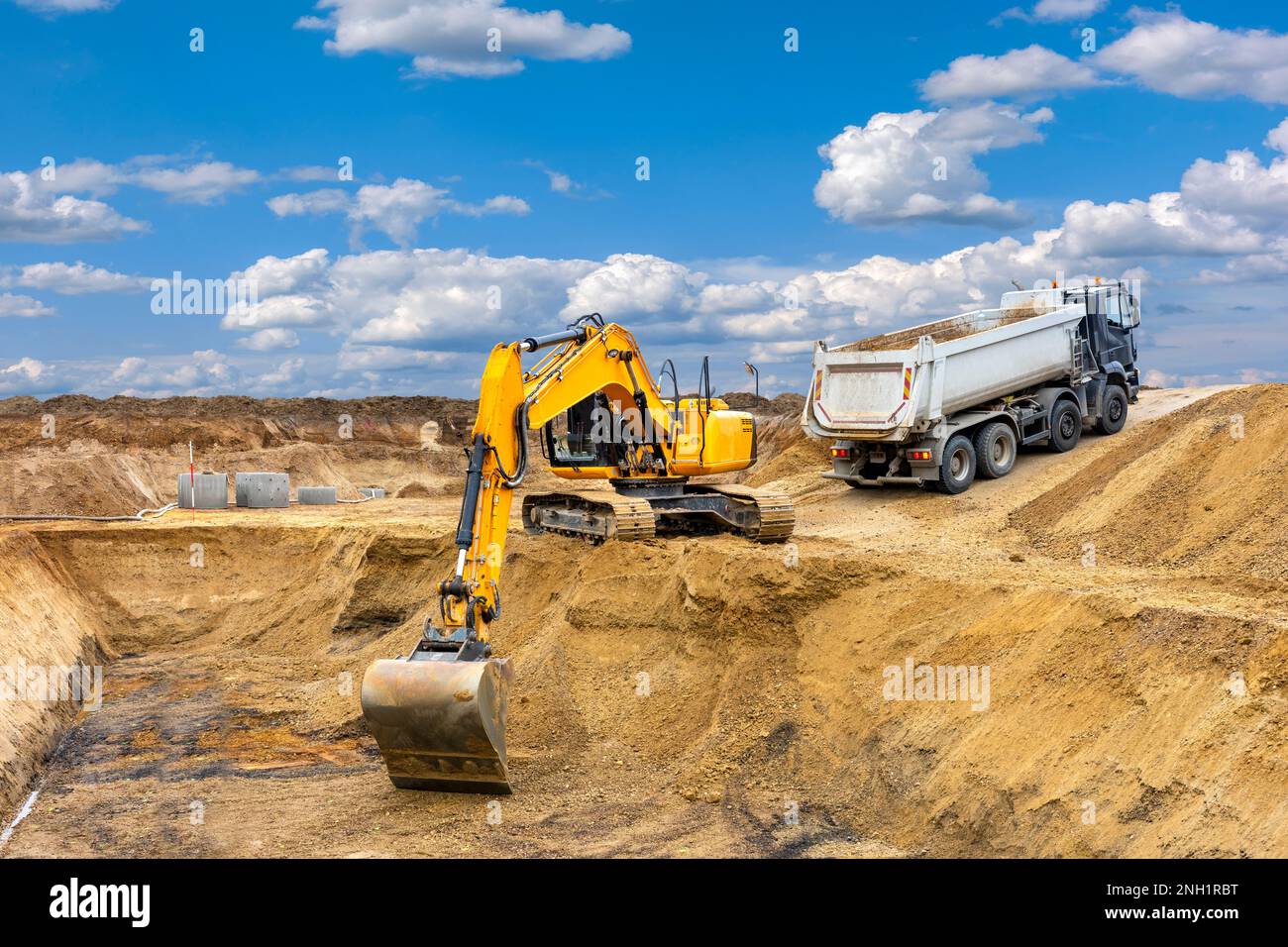 excavator is working and digging at construction site Stock Photo - Alamy