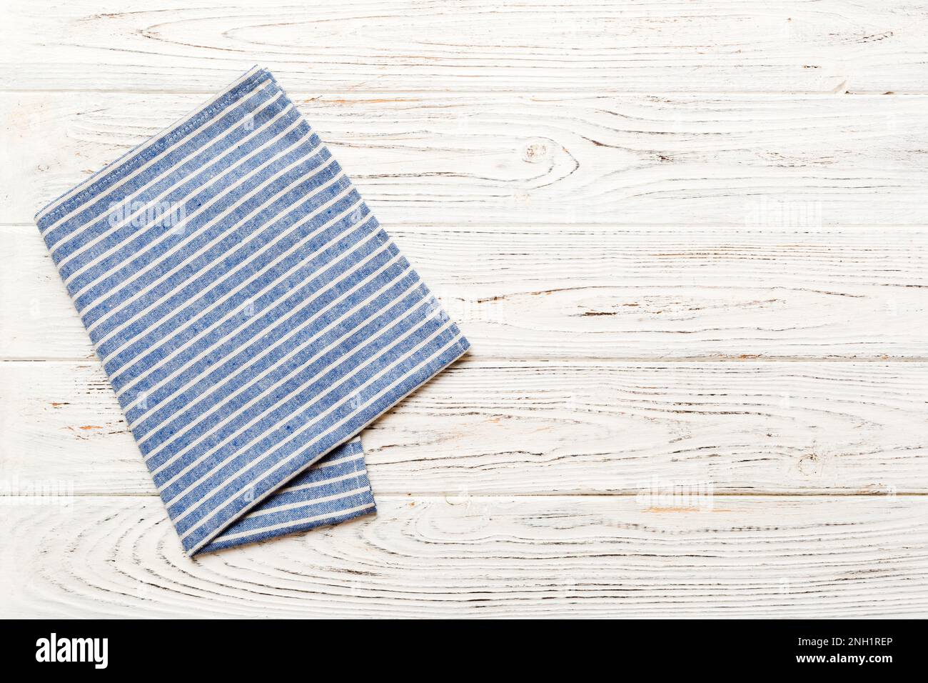 top view with blue kitchen napkin isolated on table background. Folded ...
