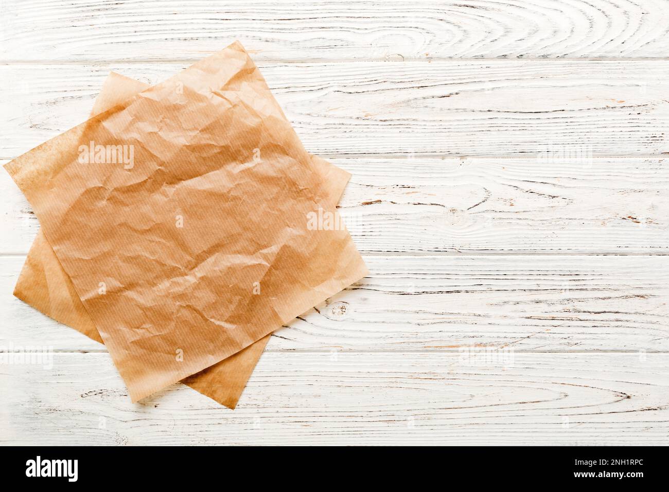 top view with baking parchment empty on table background. Folded cloth ...