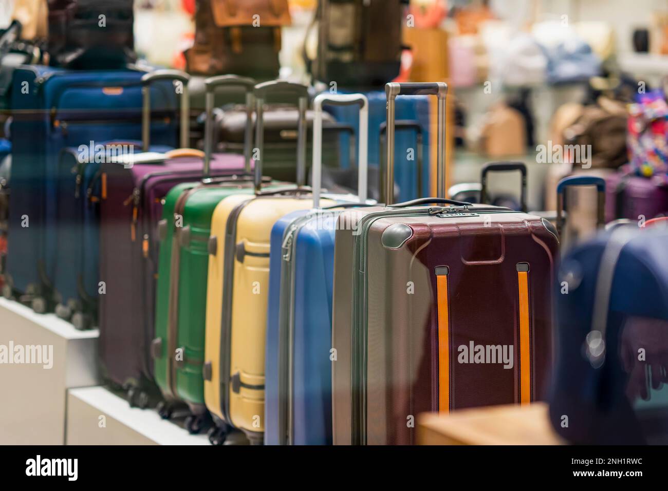 View through showcase glass on suitcases and other travel luggage close ...