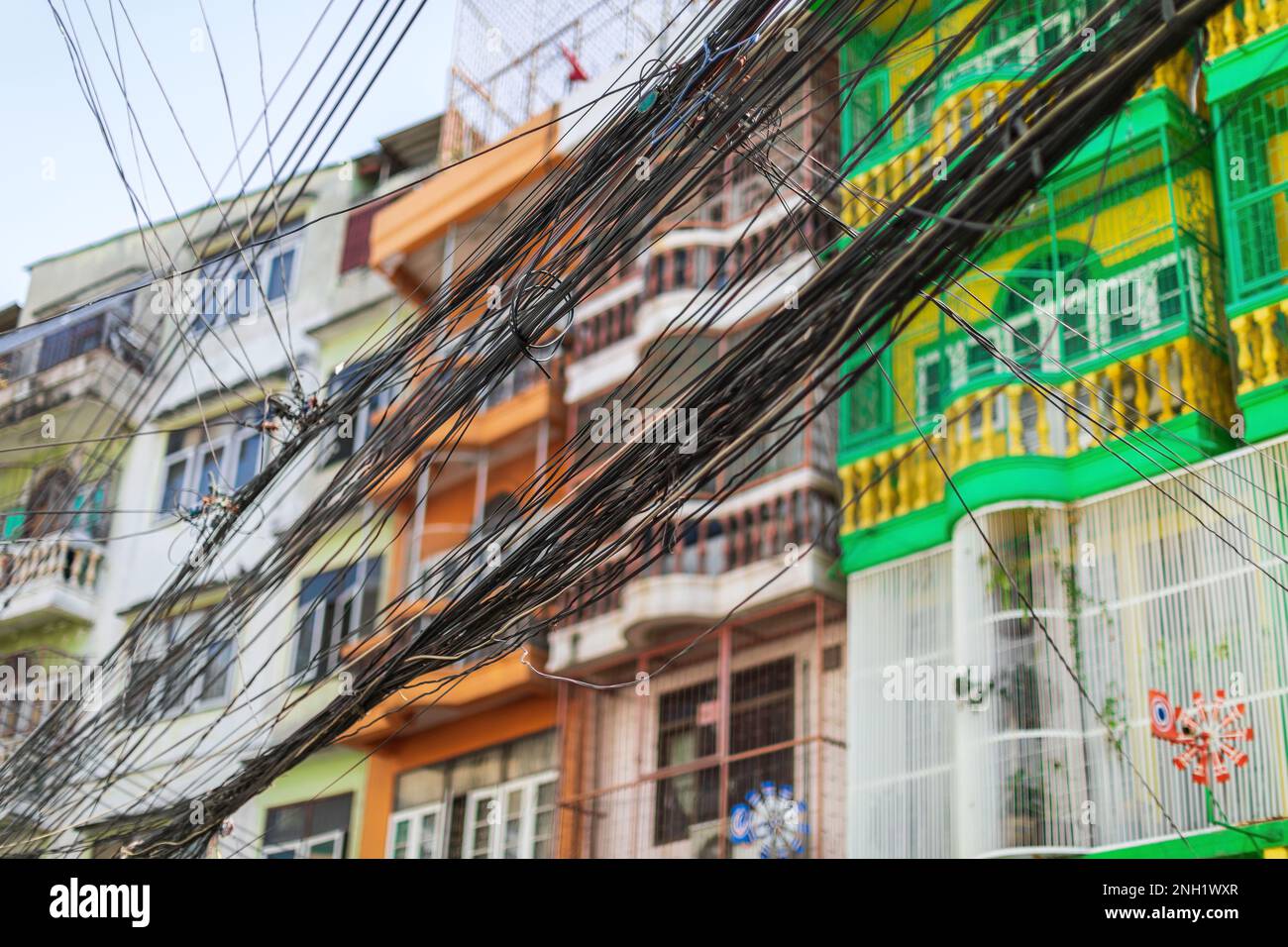 Intertwined electric wires in front of buildings which is the first ...