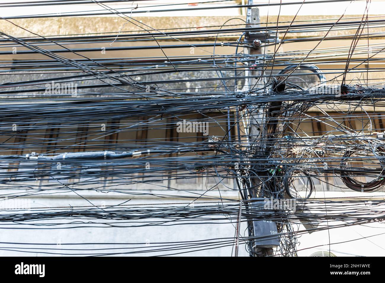 Intertwined electric wires in front of buildings which is the first ...