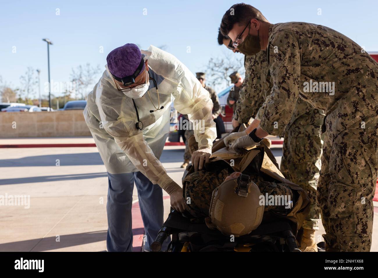 U.S. Navy medical personnel with Naval Hospital Camp Pendleton evaluate the injuries of a ...