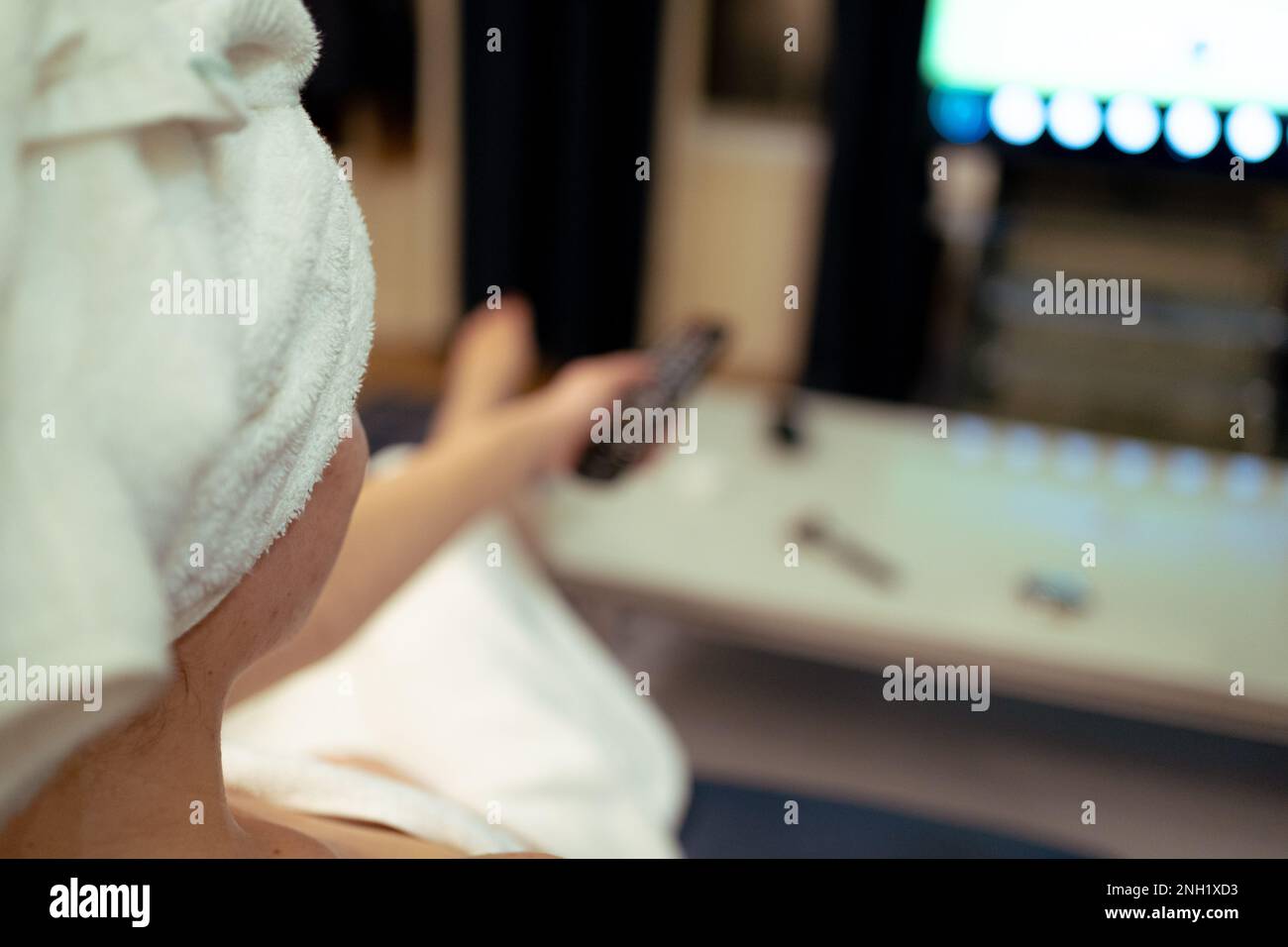 selective focus on young girl watching television relaxed after ...