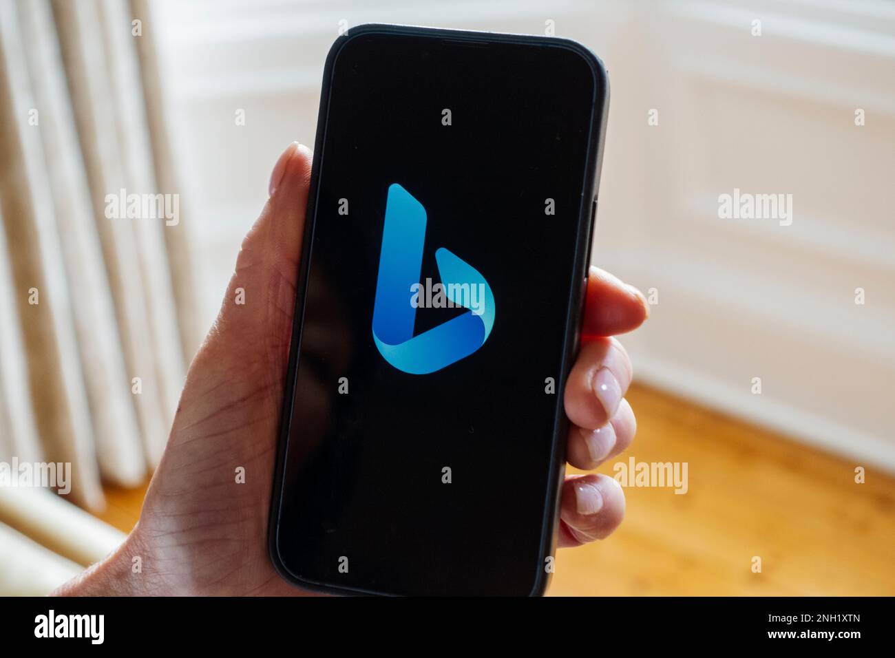 Person holds mobile phone showing new Microsoft ChatGPT OpenAI Bing ...