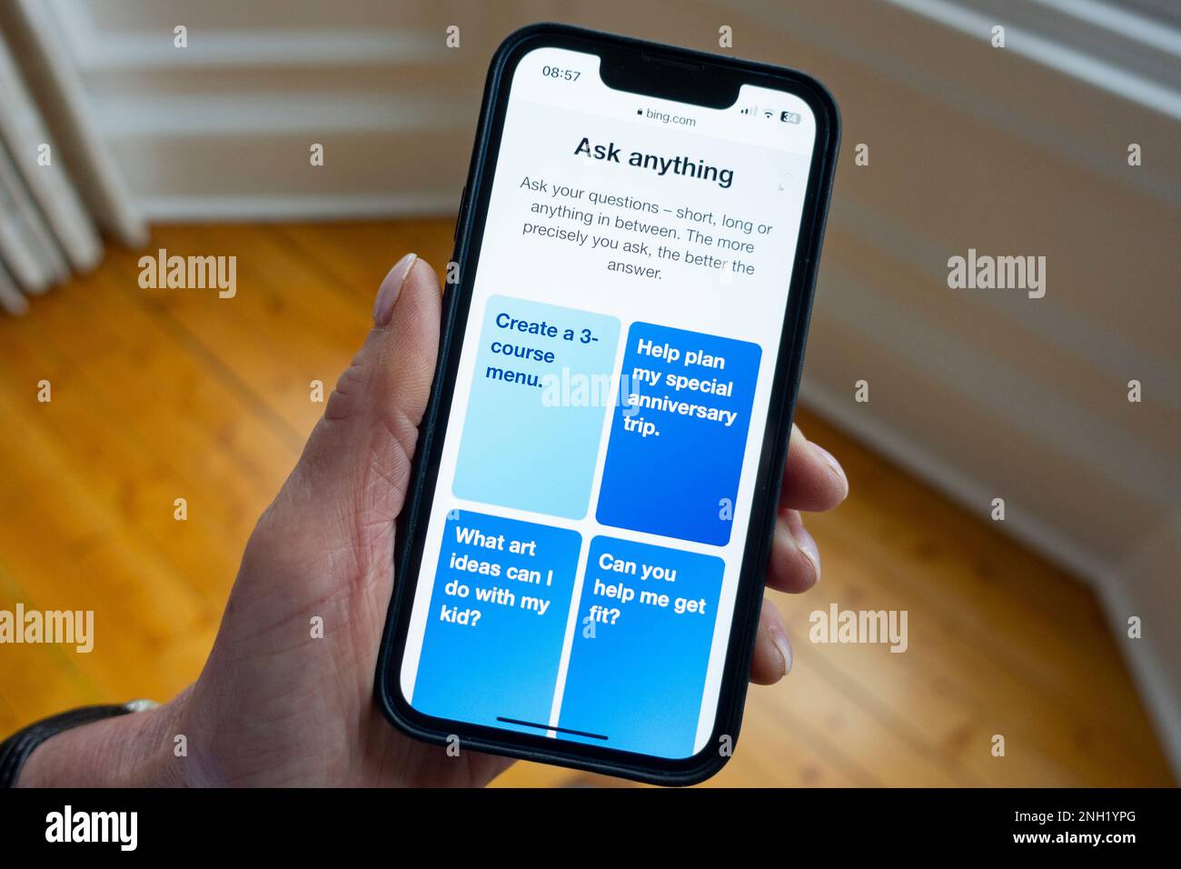 Person holds mobile phone showing new Microsoft ChatGPT OpenAI Bing ...