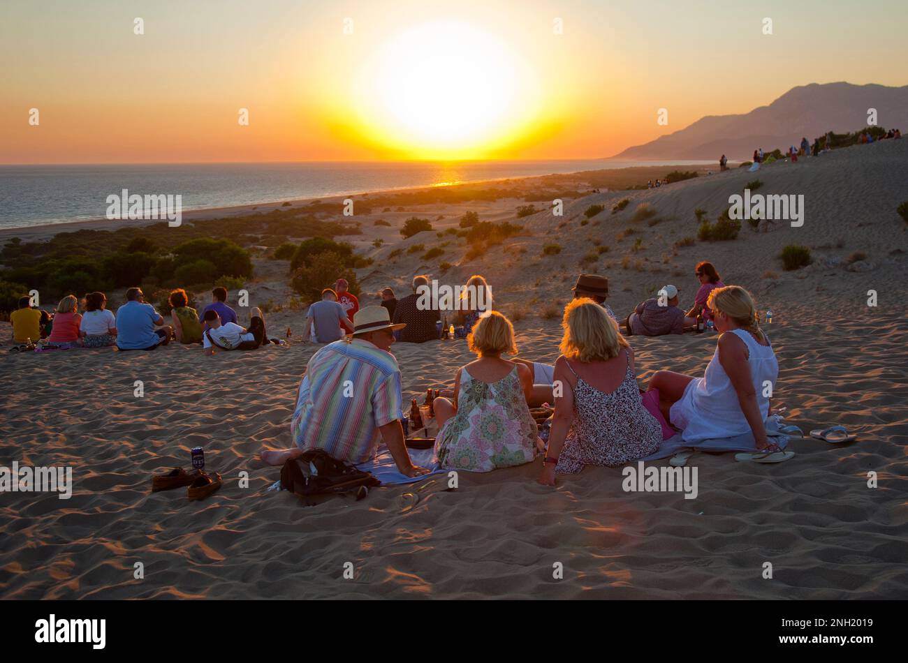 Tourists watch the sunset on Patara beach near the ancient Lycian city ...