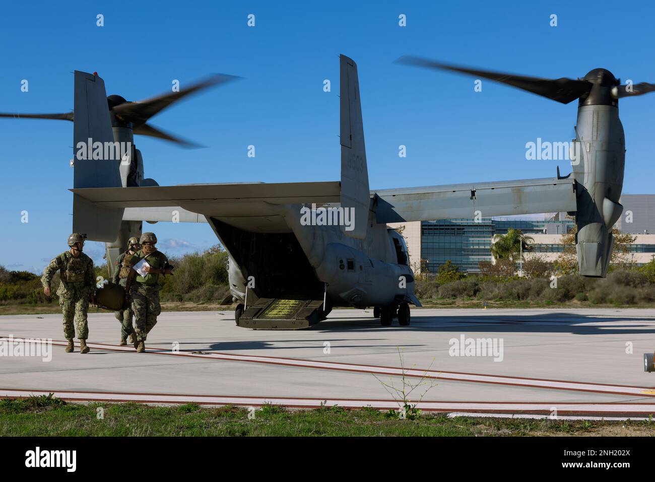 U.S. Marines and sailors move a simulated casualty off of an MV-22B ...