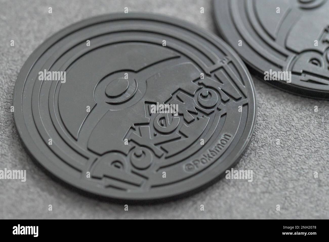 Pokémon black plastic disc within a pack of trading cards Stock Photo ...