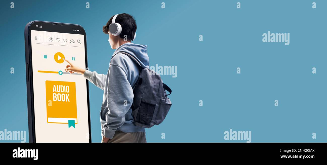 Smart student playing audio books on his smartphone, he is touching the ...