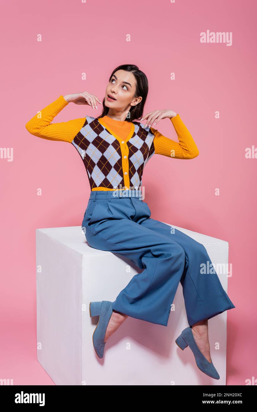 Young brunette sitting on cube hi-res stock photography and images - Alamy