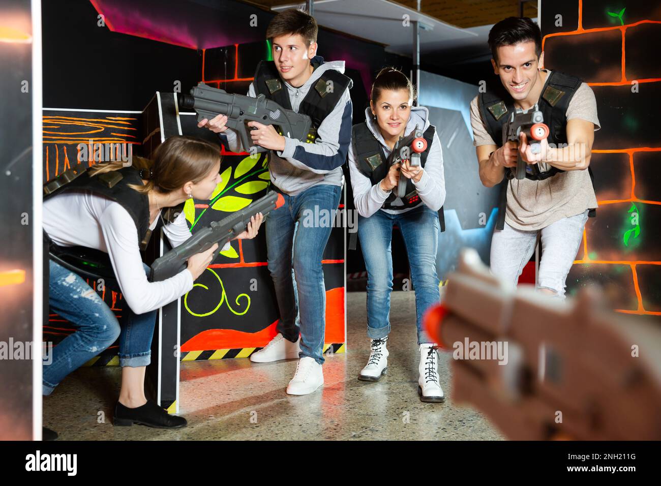 Young people playing laser tag Stock Photo - Alamy