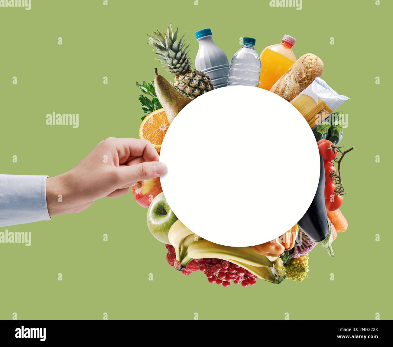 Hand holding a circular sign framed by fresh groceries, grocery ...
