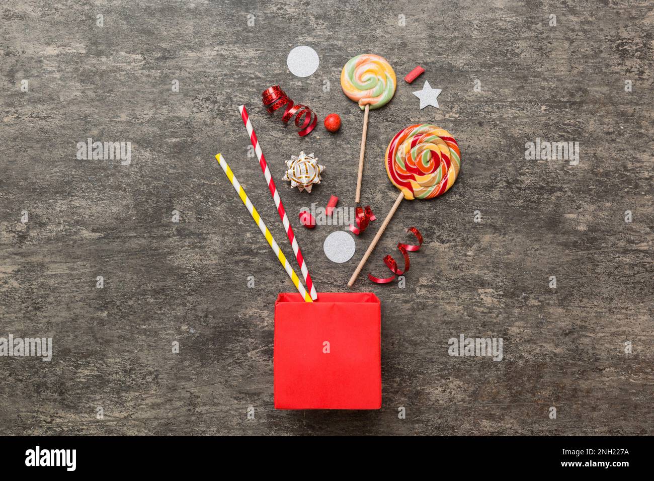 gift box in corner full of assorted traditional candies falling out on ...