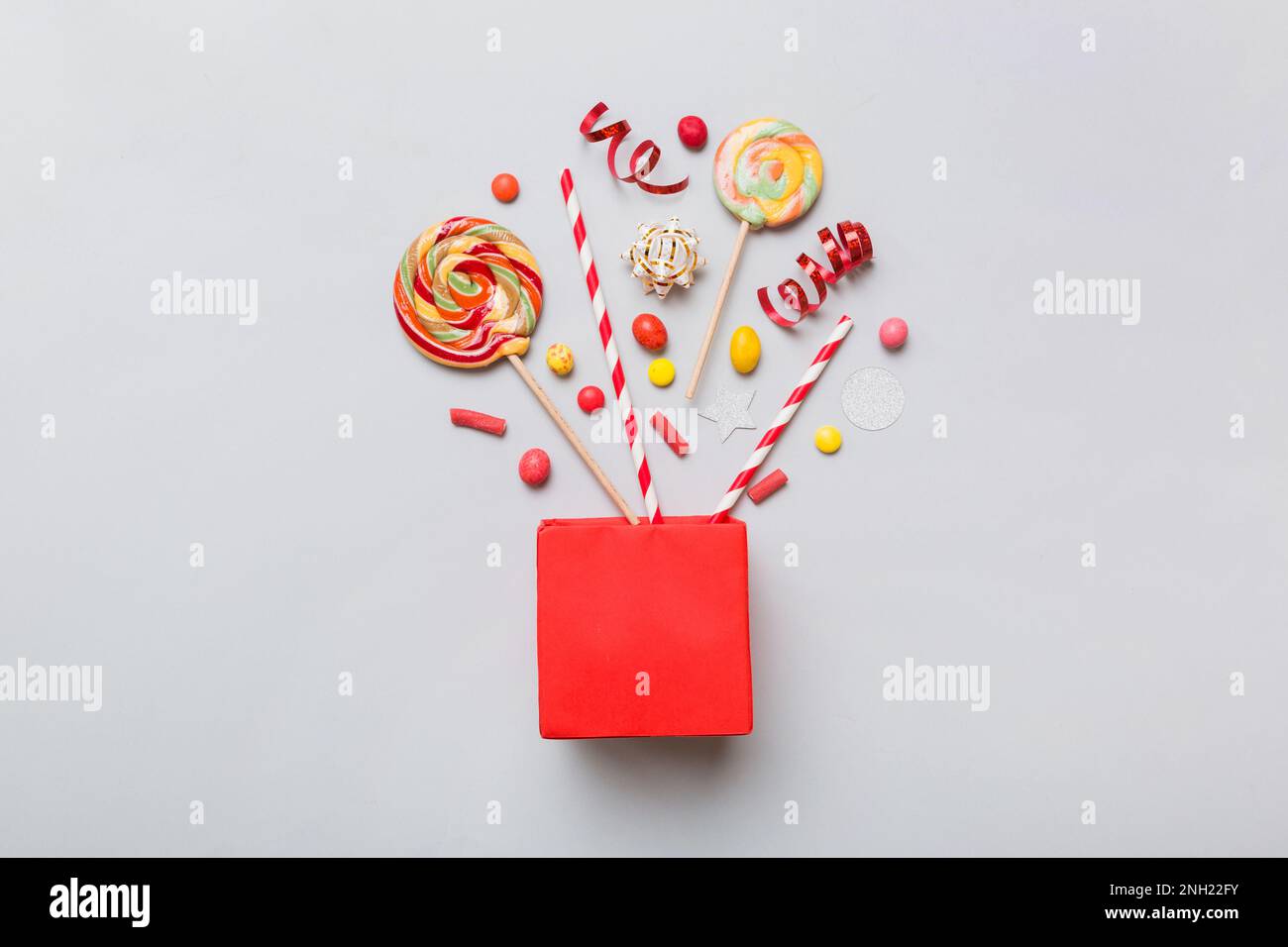 gift box in corner full of assorted traditional candies falling out on ...