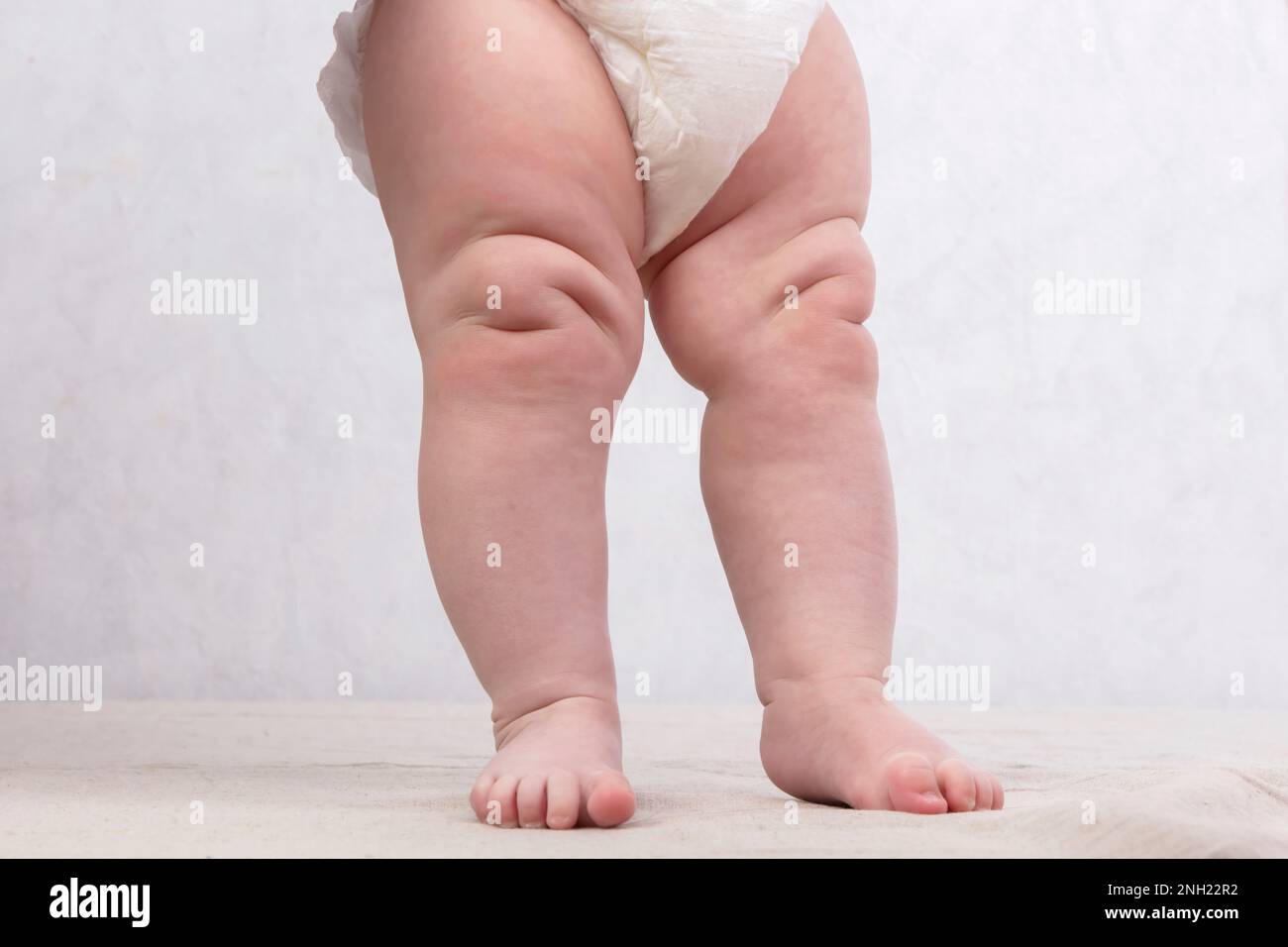 Legs of a plump newborn baby in a diaper Stock Photo - Alamy