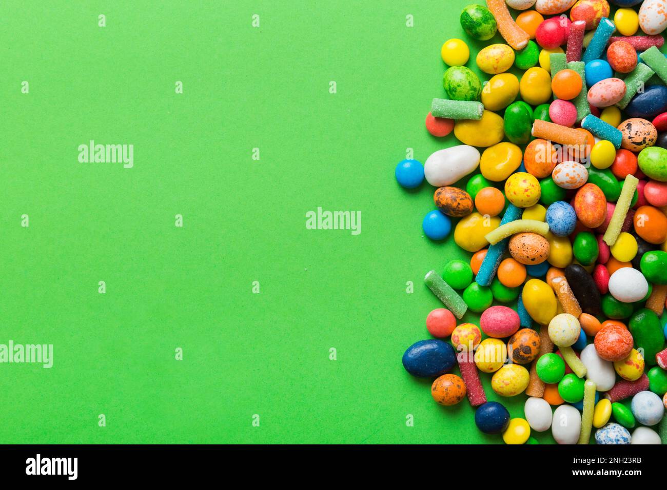Mixed collection of colorful candy, on colored background. Flat lay ...