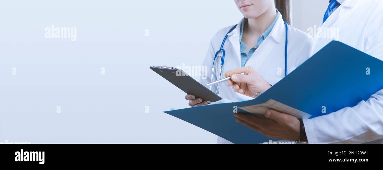 Doctors checking a patient's medical records, medicine and healthcare ...