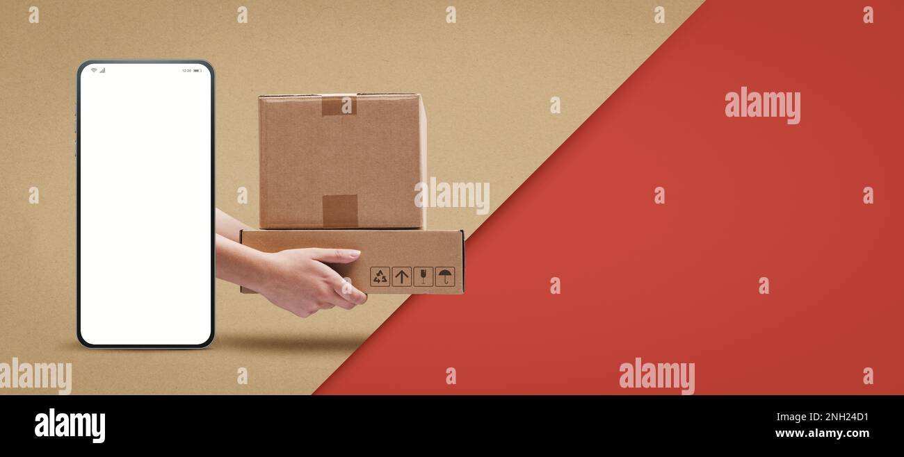 Hands holding cardboard boxes and smartphone with blank screen, express ...