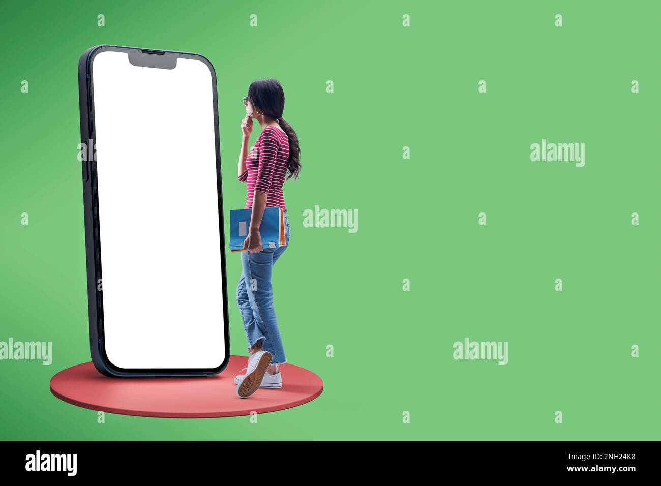 Female student holding notebooks and using a big smartphone with blank screen, e-learning ...