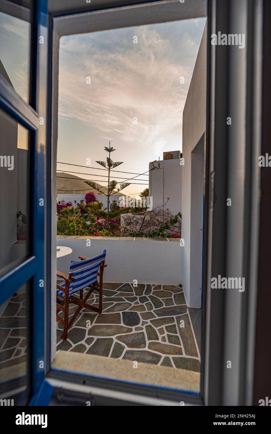 Open window overlooking Chora village at dusk, Folegandros Stock Photo ...