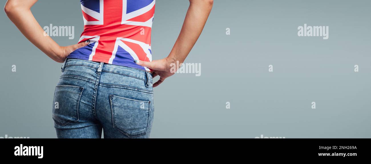 Beautiful teenager girl back view, she is wearing a British flag tank ...