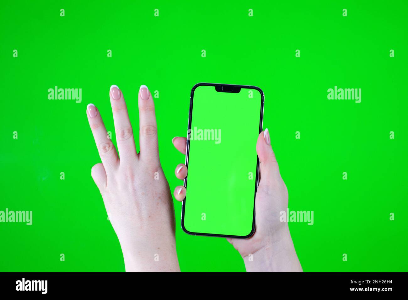 Green chromakey background on a mobile phone and in the background ...