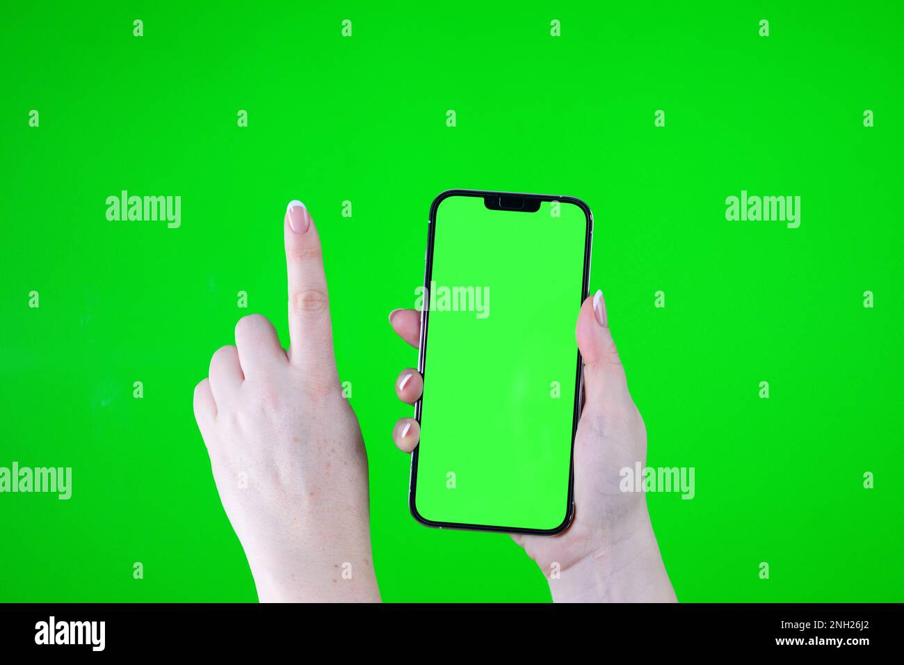 Green chromakey background on a mobile phone and in the background ...