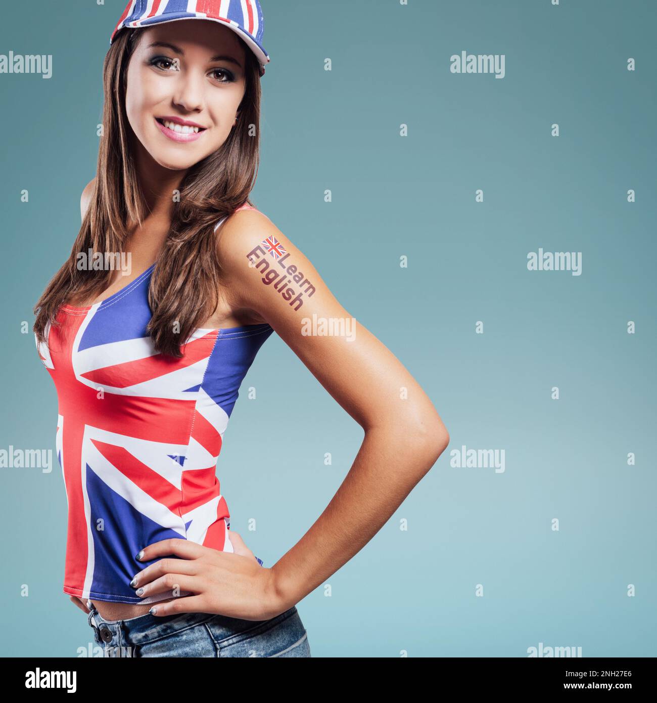 Cool young woman wearing a UK flag tank top and learning English, copy ...