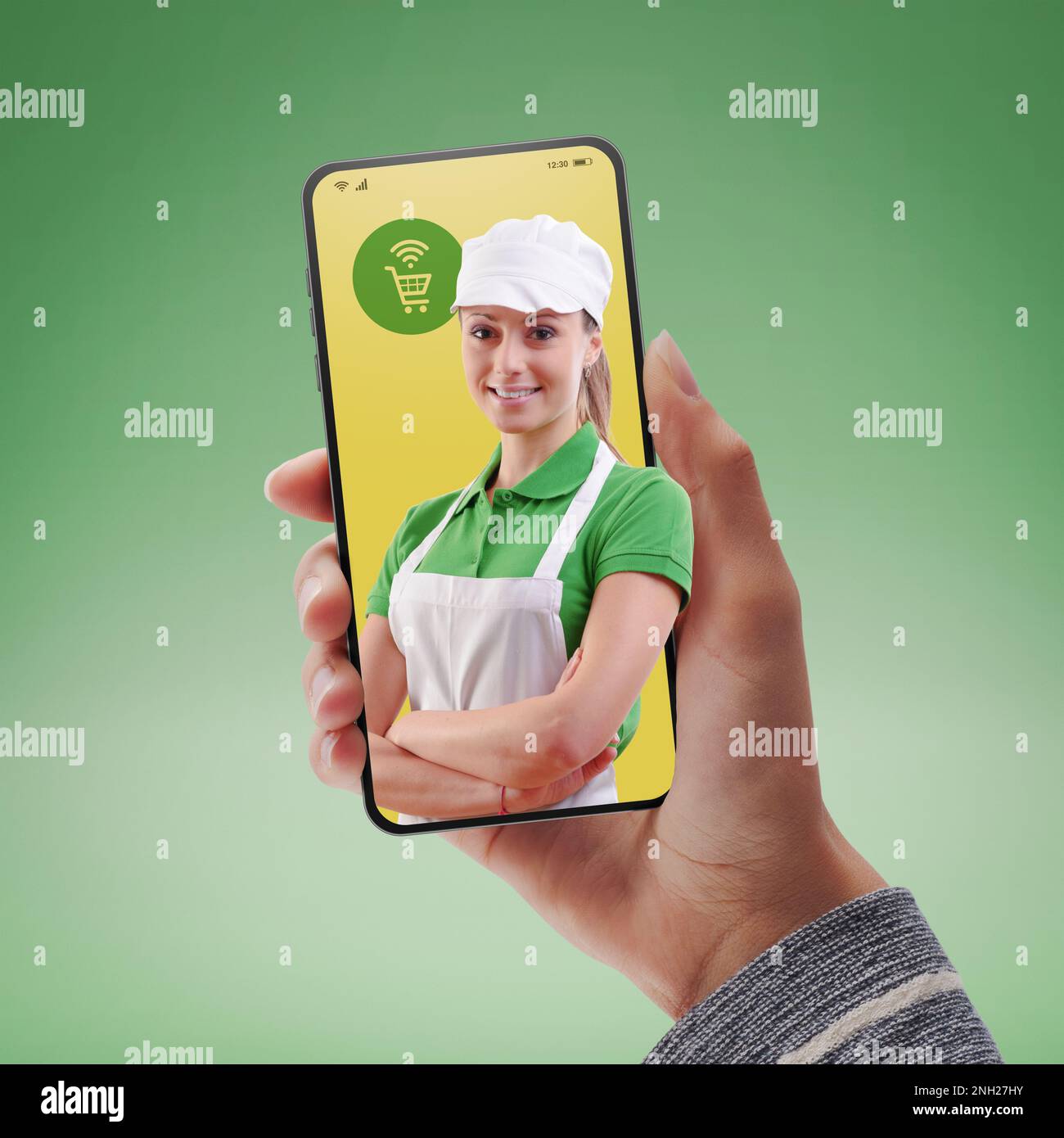 Customer holding a smartphone and shop assistant: online grocery ...