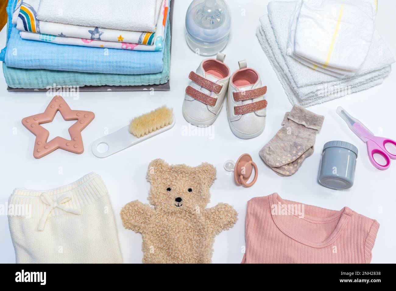 Concept of giving birth. Set of clothes and accessories for newborn on ...