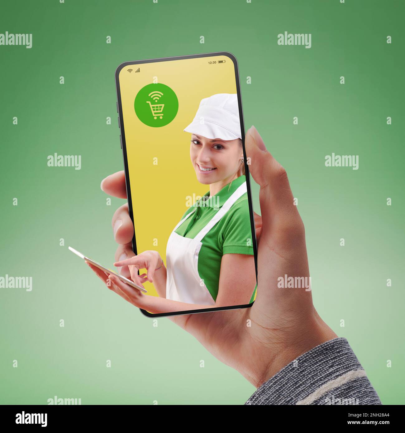 Customer holding a smartphone and shop assistant: online grocery ...