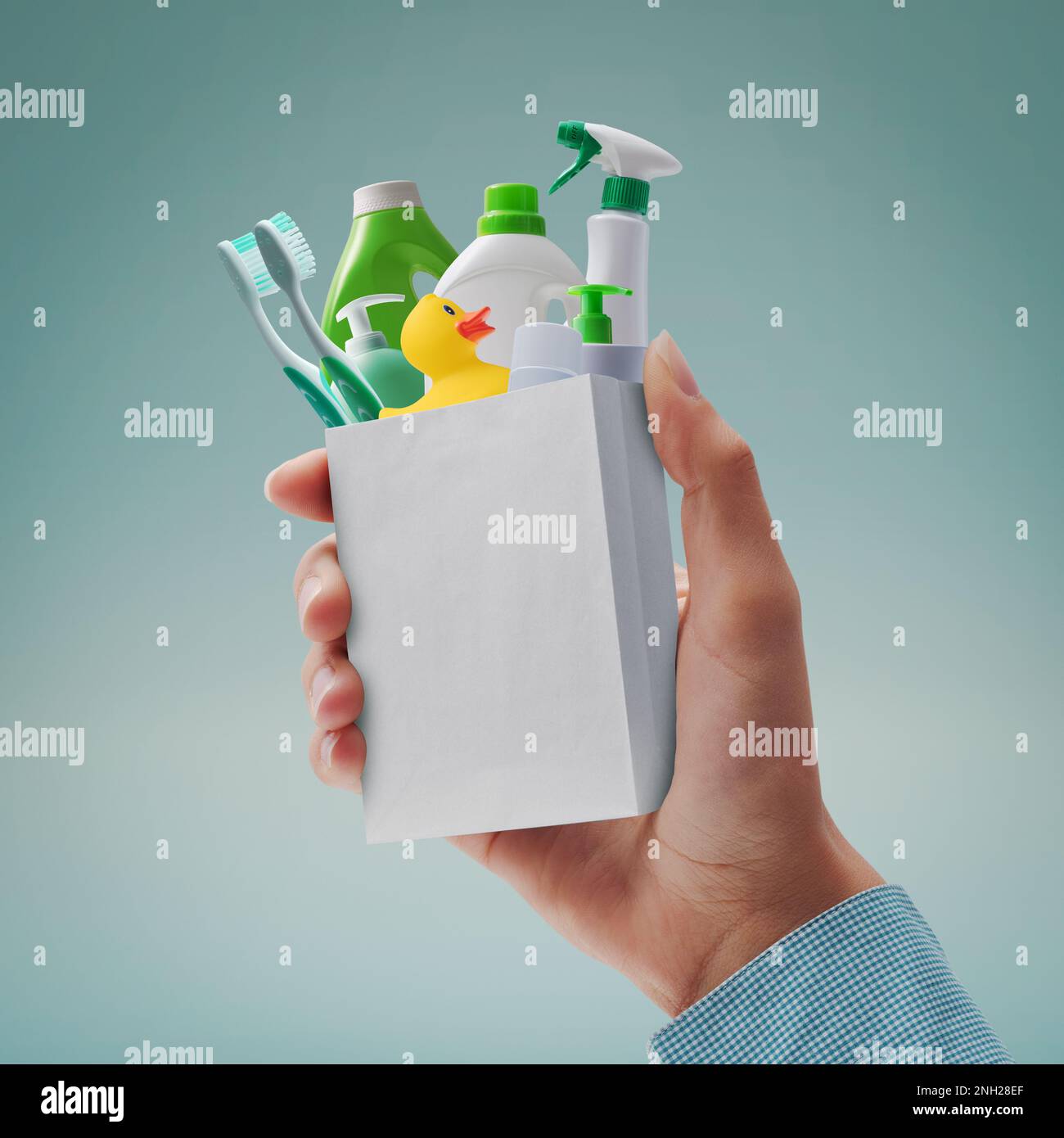 Customer holding a tiny shopping bag with assorted household items ...
