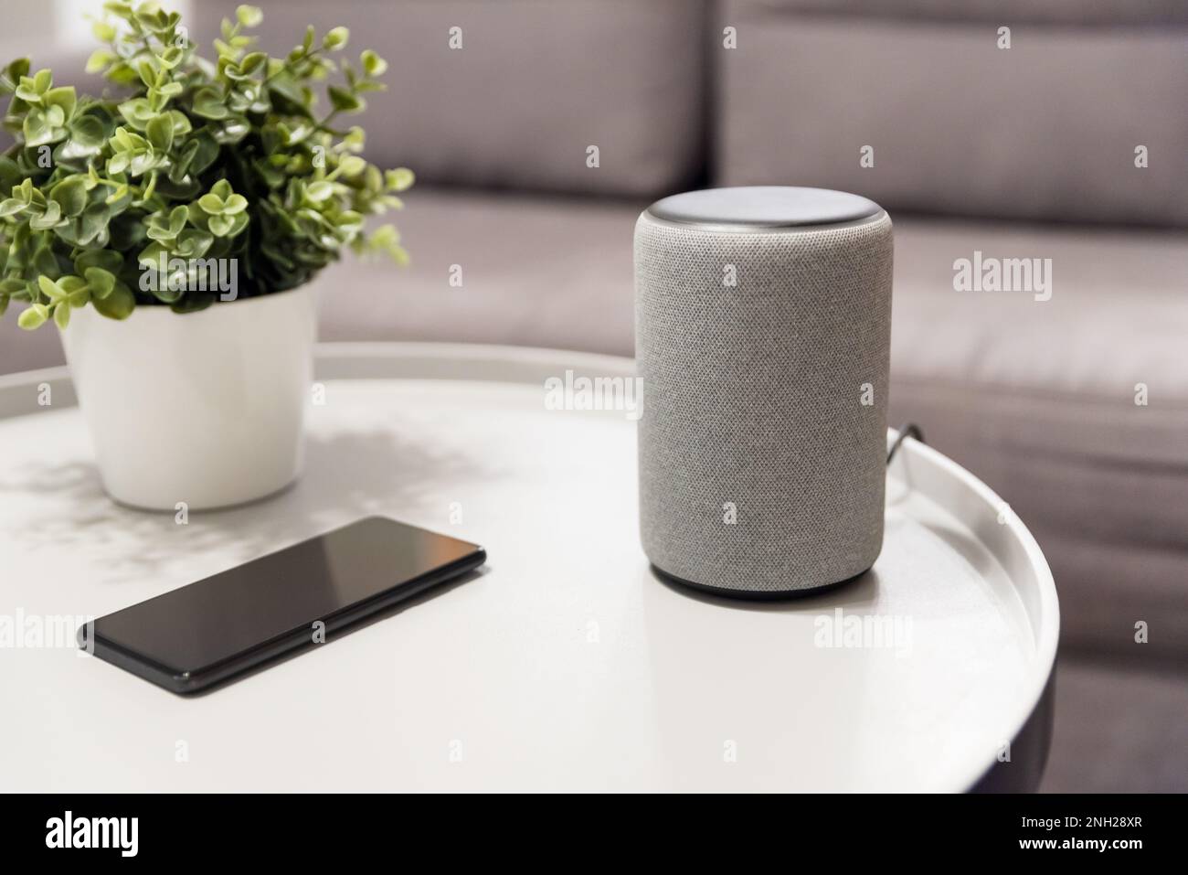 Smart speaker device in living room. Smart home system Stock Photo - Alamy