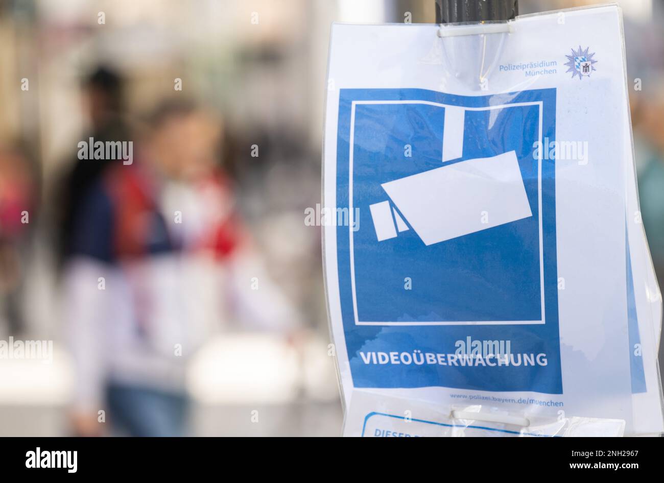 Munich, Germany. 20th Feb, 2023. A sign on a lamp post alerts passersby ...