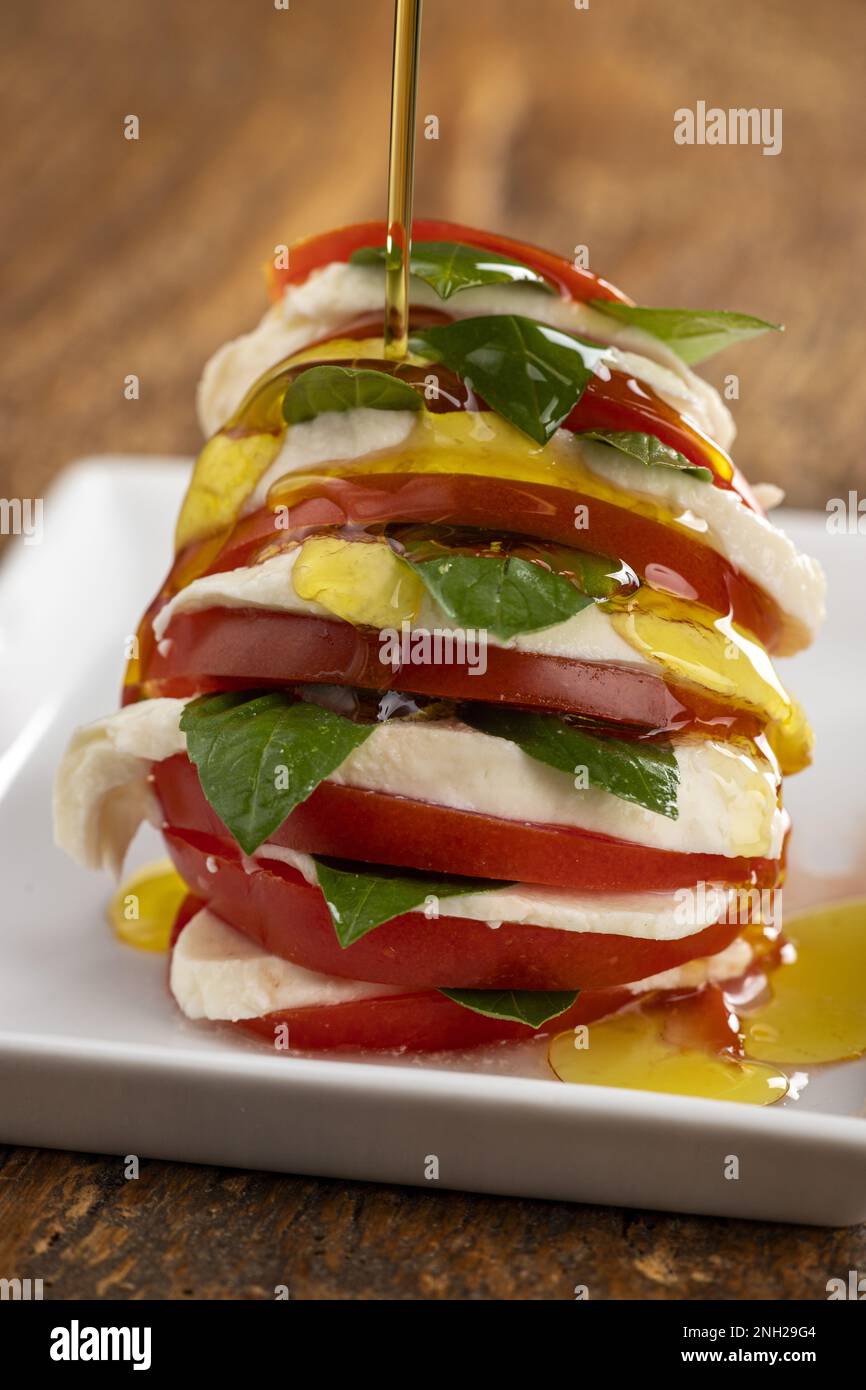 Stack Insalada Caprese With Olive Oil Stock Photo - Alamy